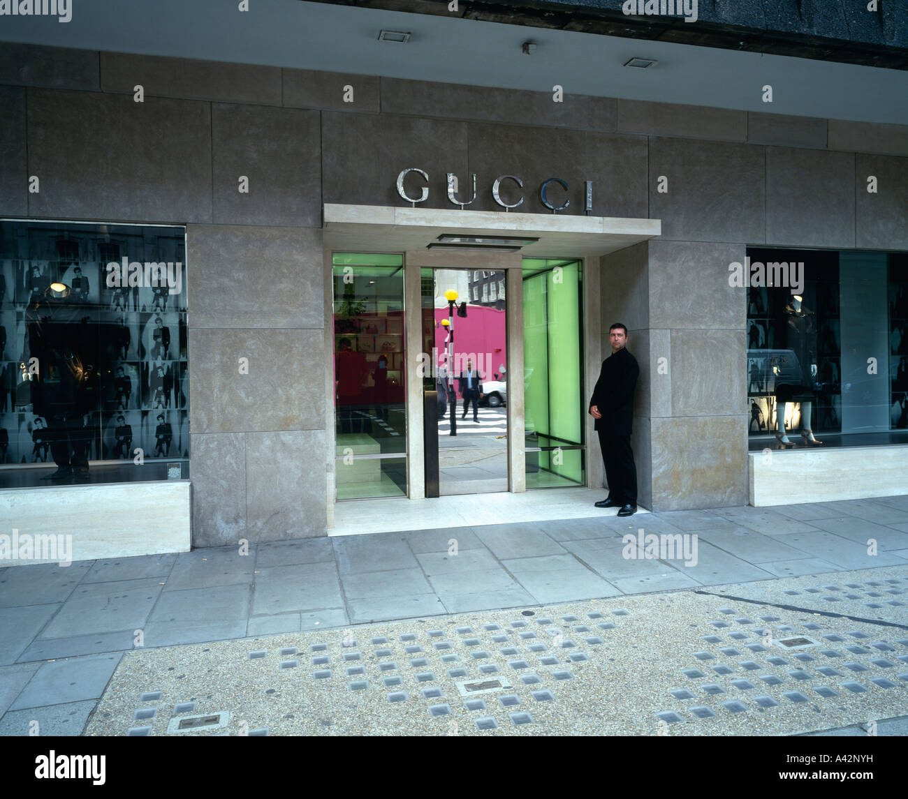 Doorman standing outside the Gucci shop in London Stock Photo - Alamy