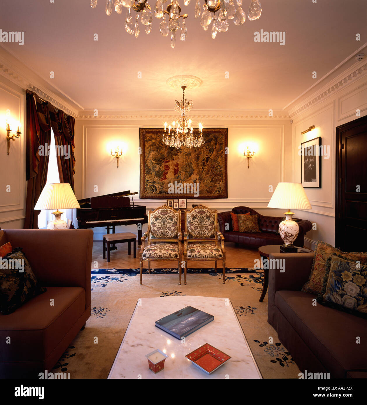 Marble coffee table in sittingroom with lighted wall lights and lamps ...