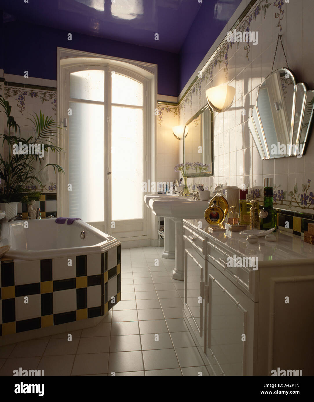 Blue and white tiled bath surround in traditional bathroom with tiled ...