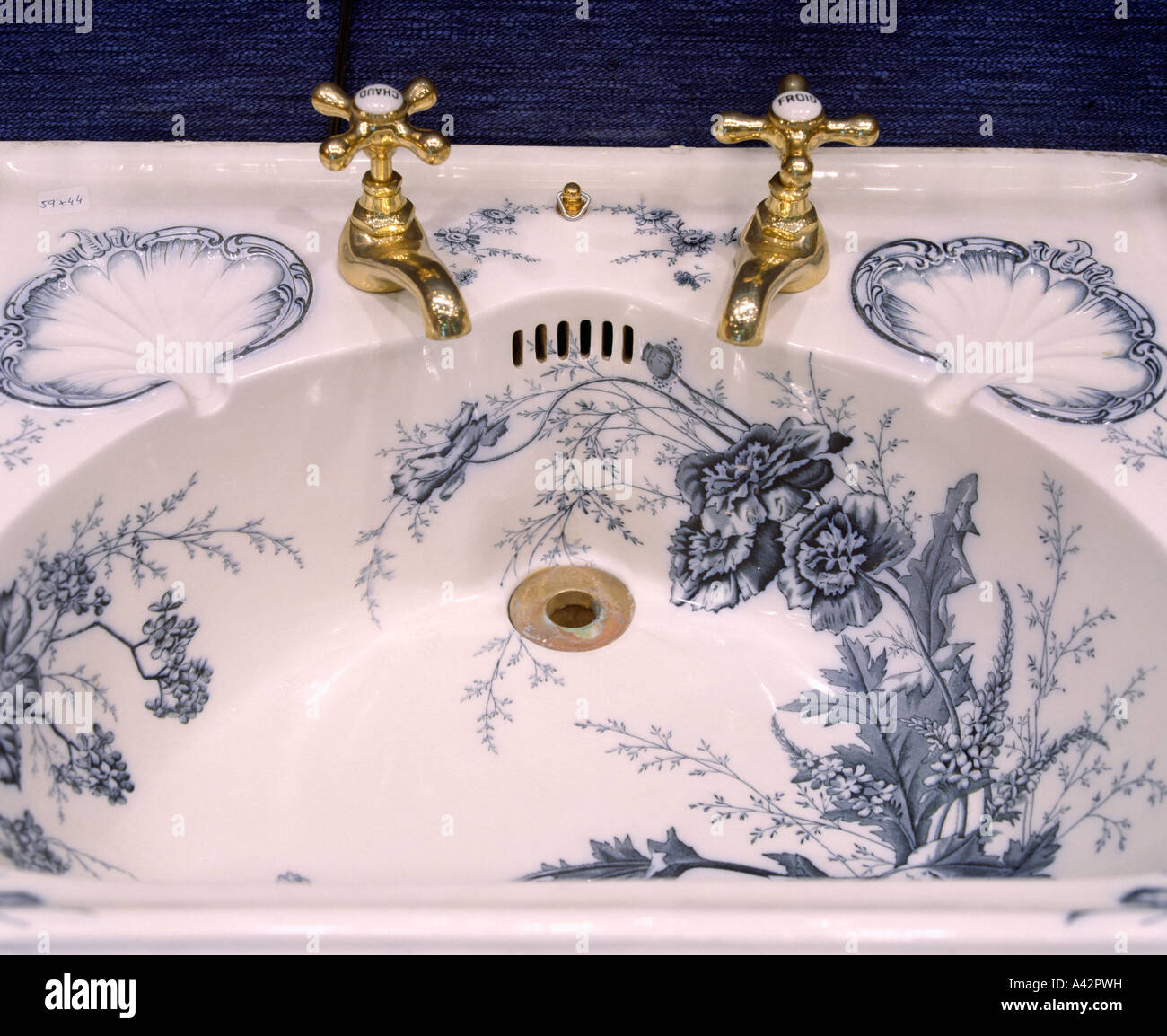 Close-up of blue and white porcelain basin and brass taps Stock Photo ...