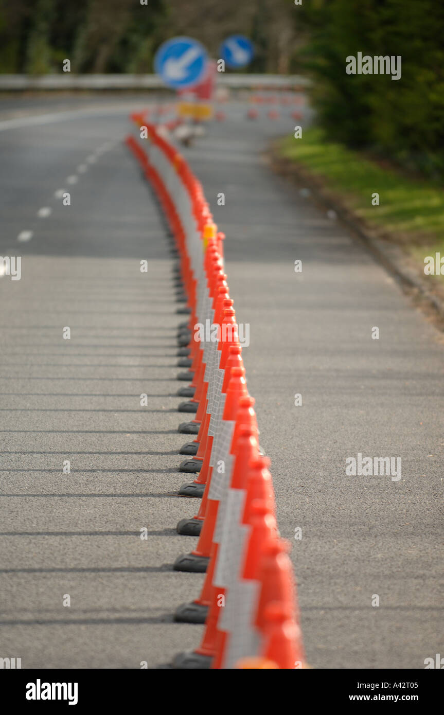 Red road traffic cones lined up along the side of a road Stock Photo ...