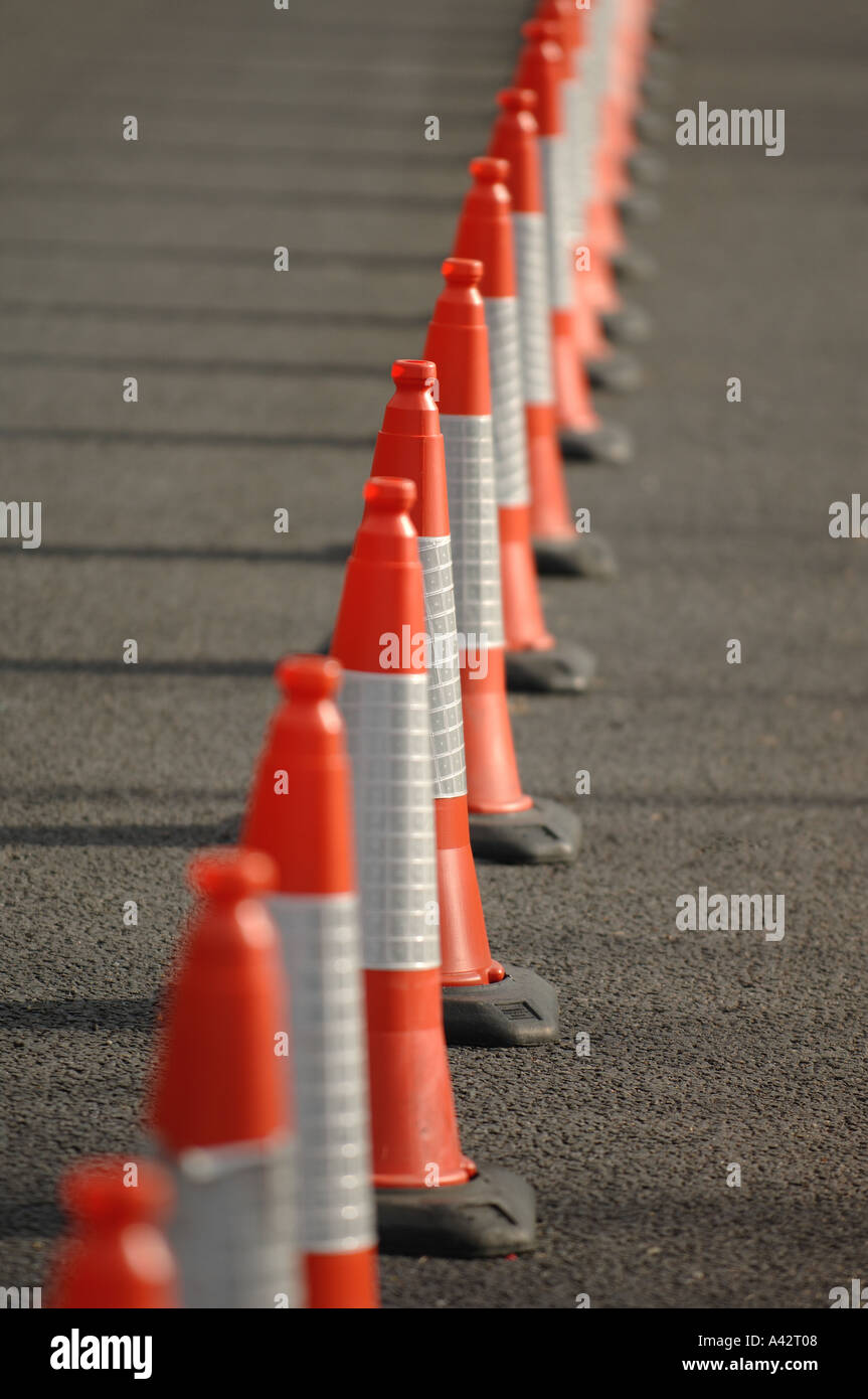 Red road traffic cones lined up along the side of a road Stock Photo ...
