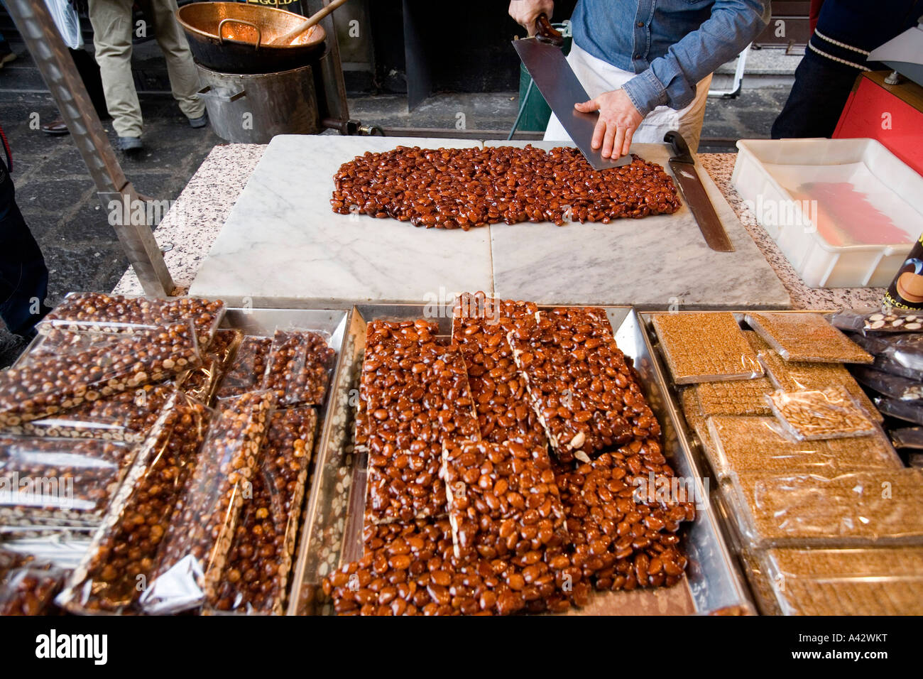 Man making mandorlata almonds sweet in the street of Catania Sicily ...