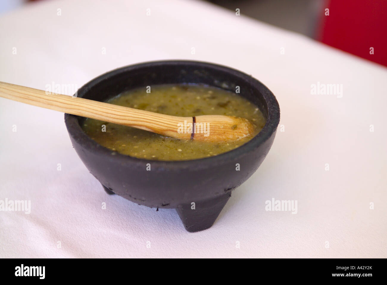 Bowl of green salsa verde picante condiment on a restaurant table in ...