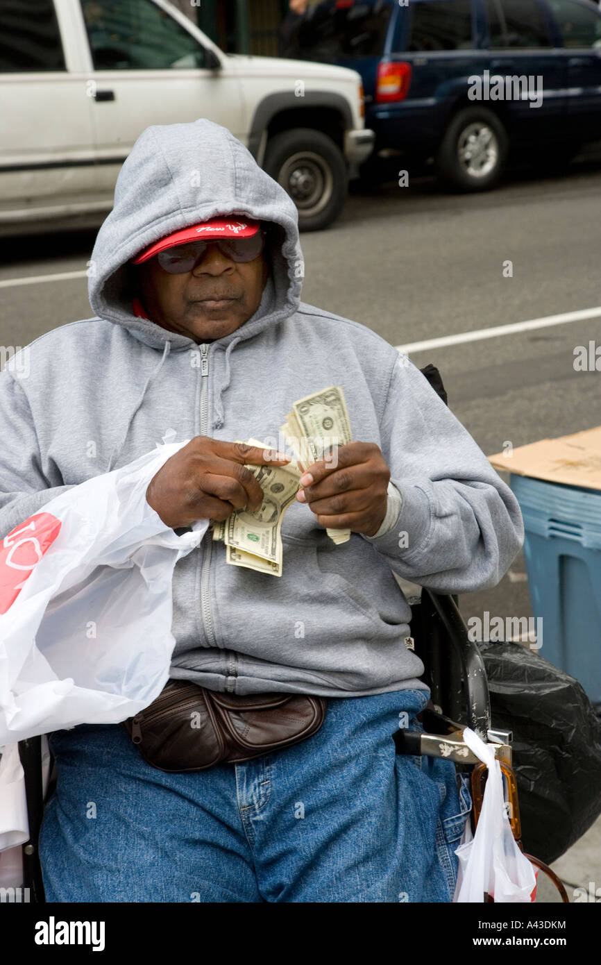 black man counting dollar bills Stock Photo - Alamy