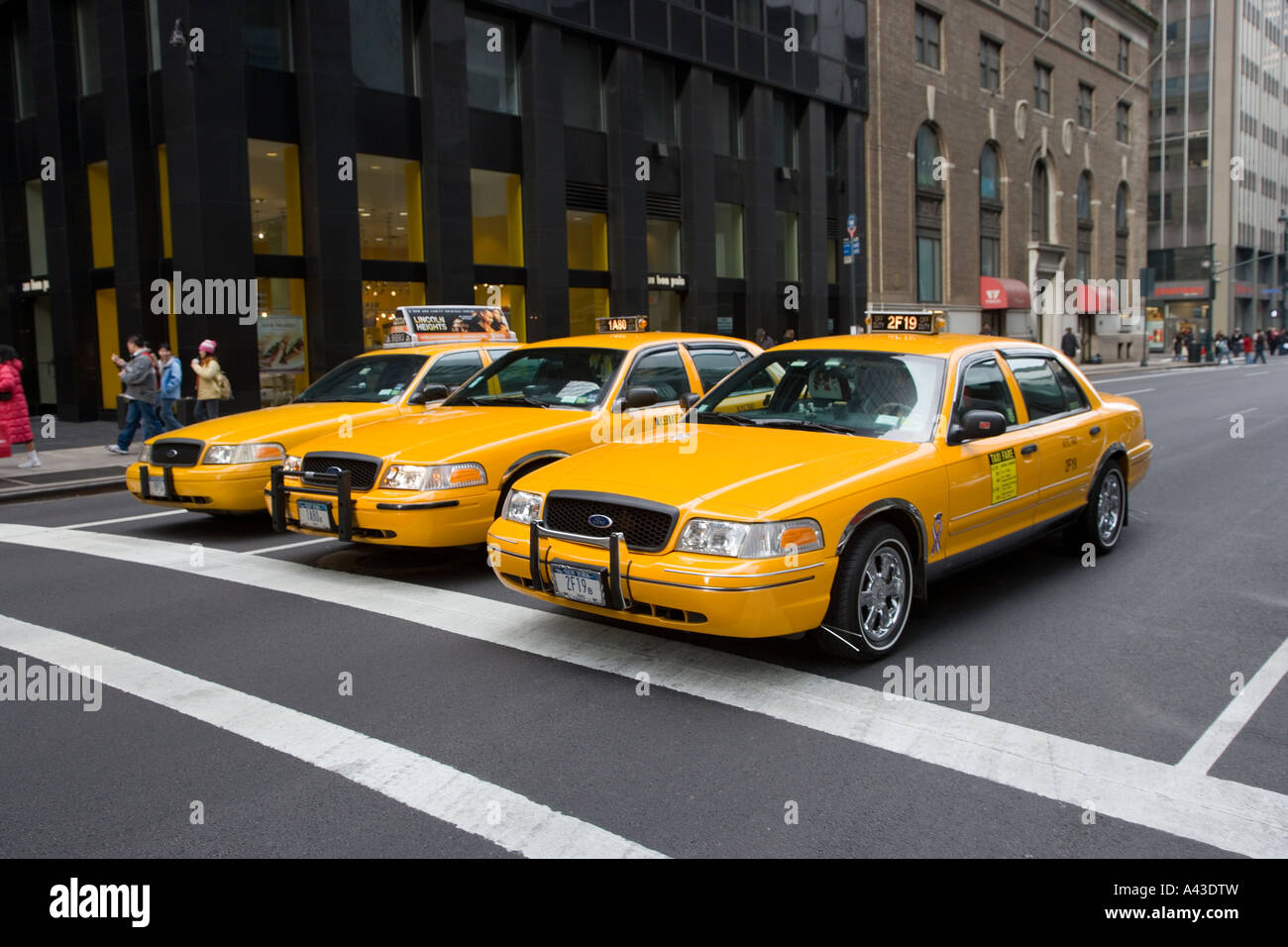 three yellow taxi cabs in a row Stock Photo - Alamy