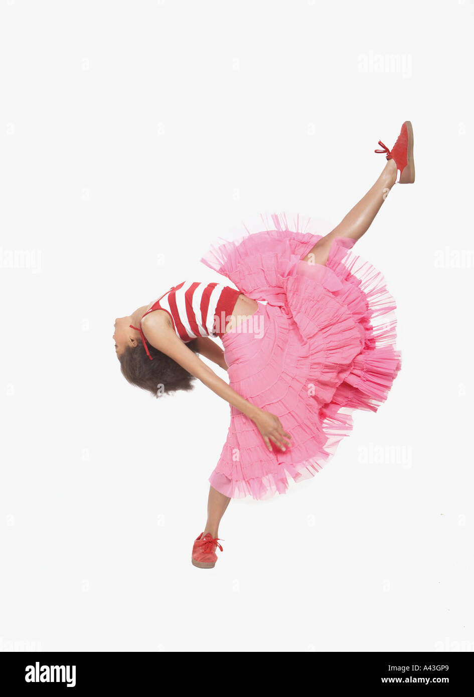 Full view of woman kicking high in air Stock Photo - Alamy