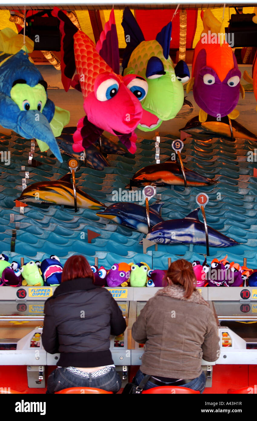 Players enjoy a fairground game of racing dolphins on the Palace Pier ...