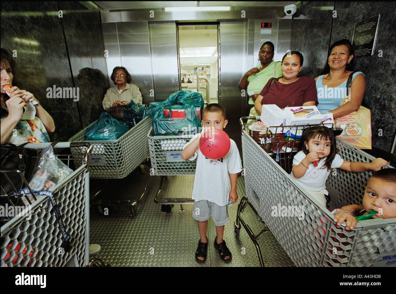Walmart shoppers in elevator Stock Photo - Alamy