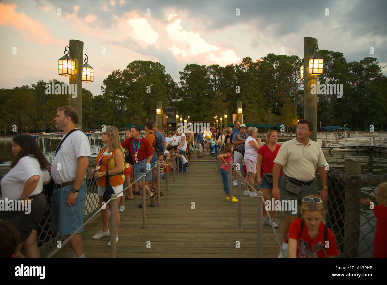 Park visitors queue up to get on boat transportation at Fort Wilderness ...
