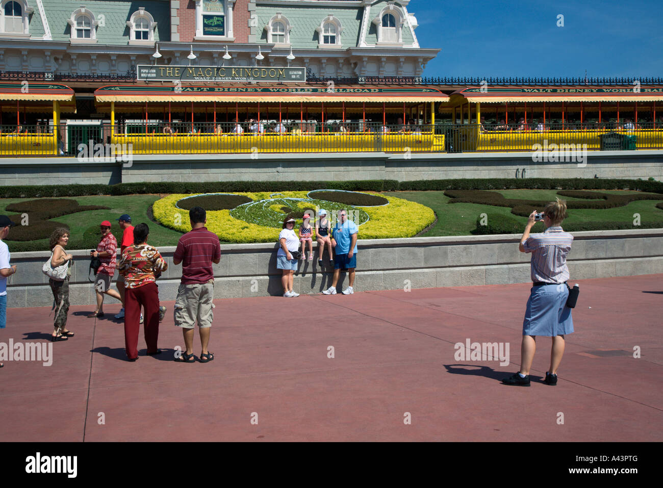 Park guests taking pictures outside entrance to the Magic Kingdom at ...