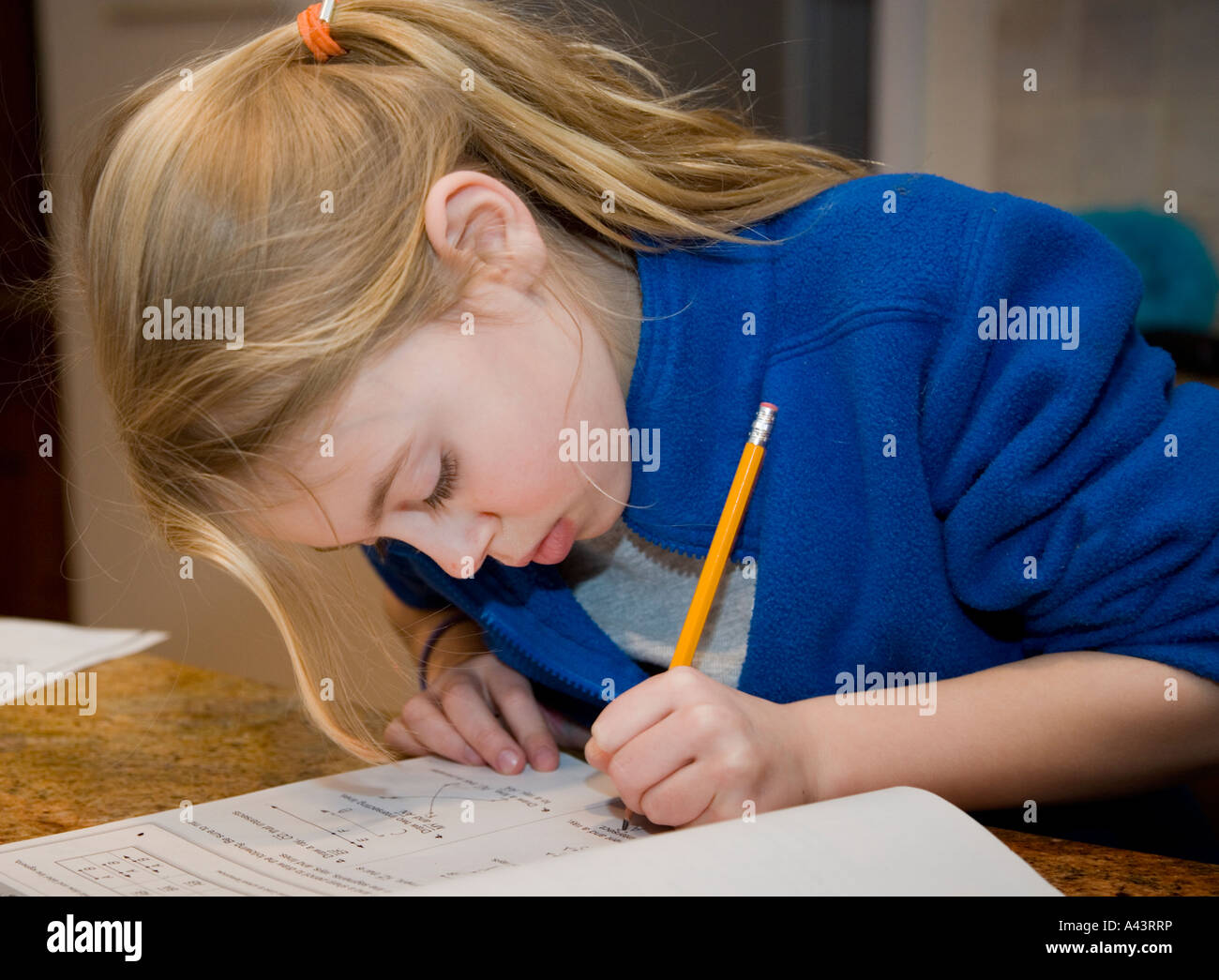 Nine year old girl doing her homework Stock Photo - Alamy