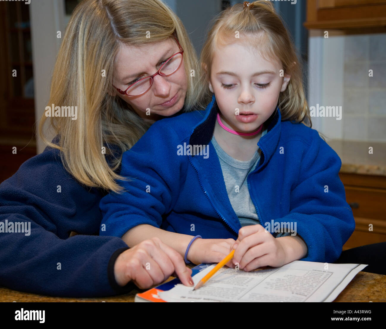 Mother helping a child with her homework Stock Photo - Alamy