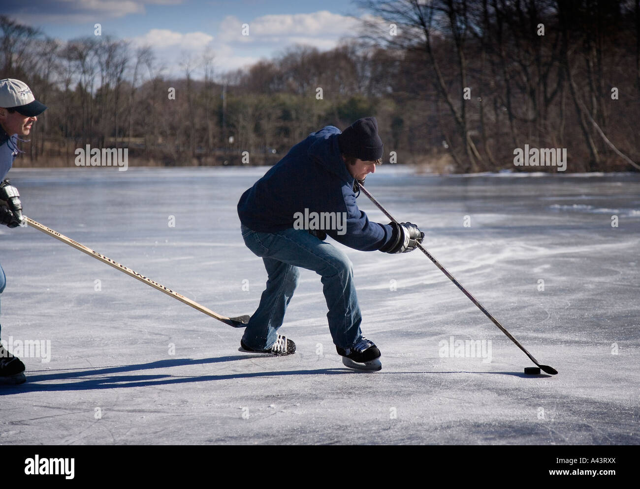 Playing ice hockey on a frozen pond Stock Photo - Alamy