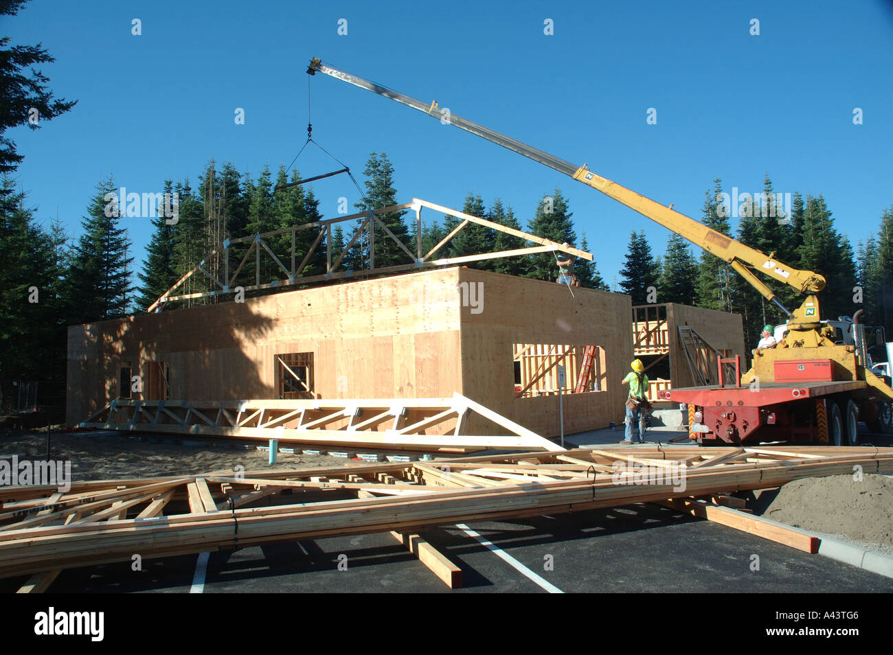 Crane lifting wood truss roof hi-res stock photography and images - Alamy