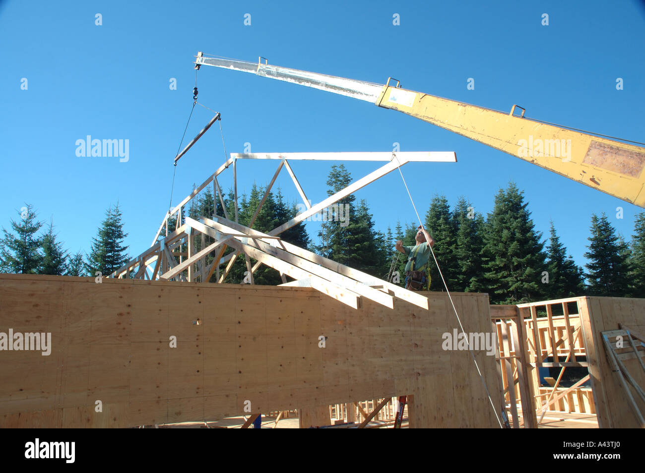 Construction - Crane Putting Wooden Roof Truss Into Place Stock Photo ...