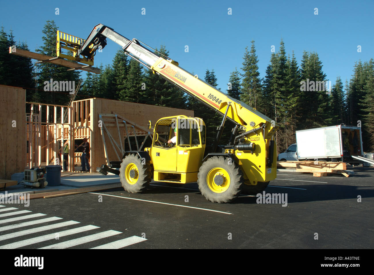 Construction - Forklift Machine Lifts Wooden Beam Into Place Stock ...