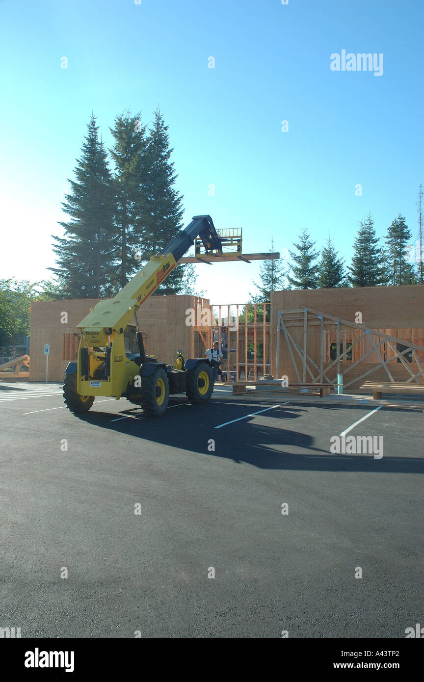 Construction - Forklift Lifts Wood Beam Into Place Stock Photo - Alamy
