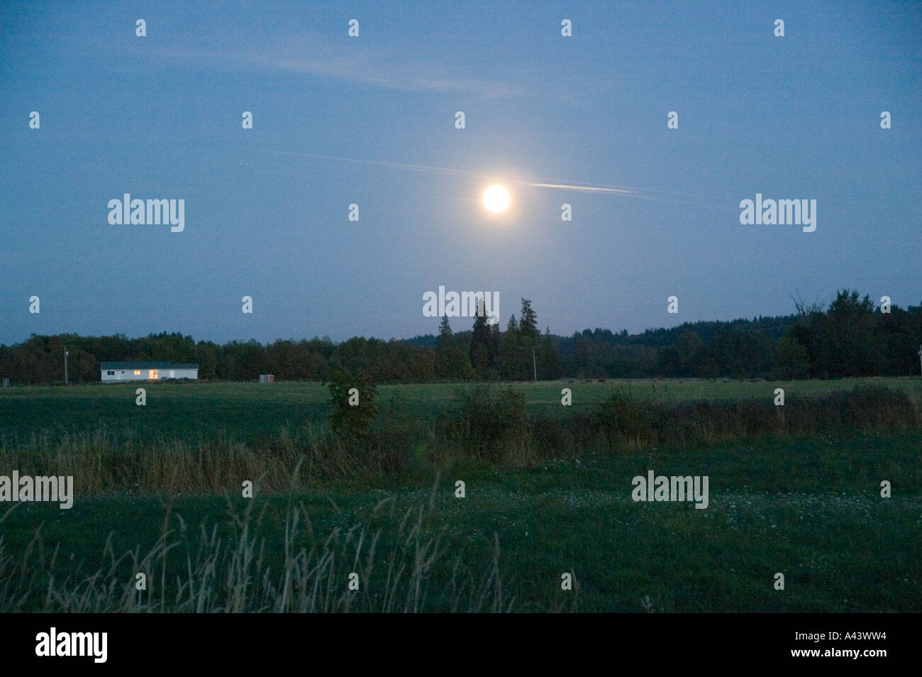 A Little House On A Moonlit Prairie In The Evening Stock Photo - Alamy