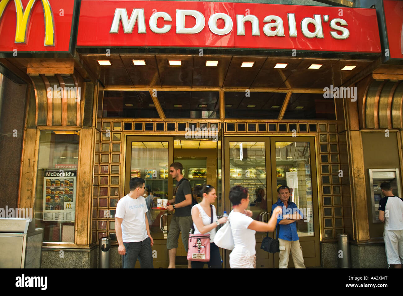 HUNGARY Budapest Man walk out of McDonalds restaurant people walk past ...