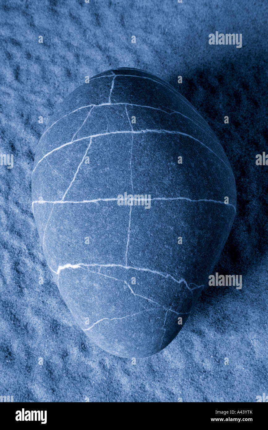 Elliptical ancient smooth stone with irregular geometric markings ...