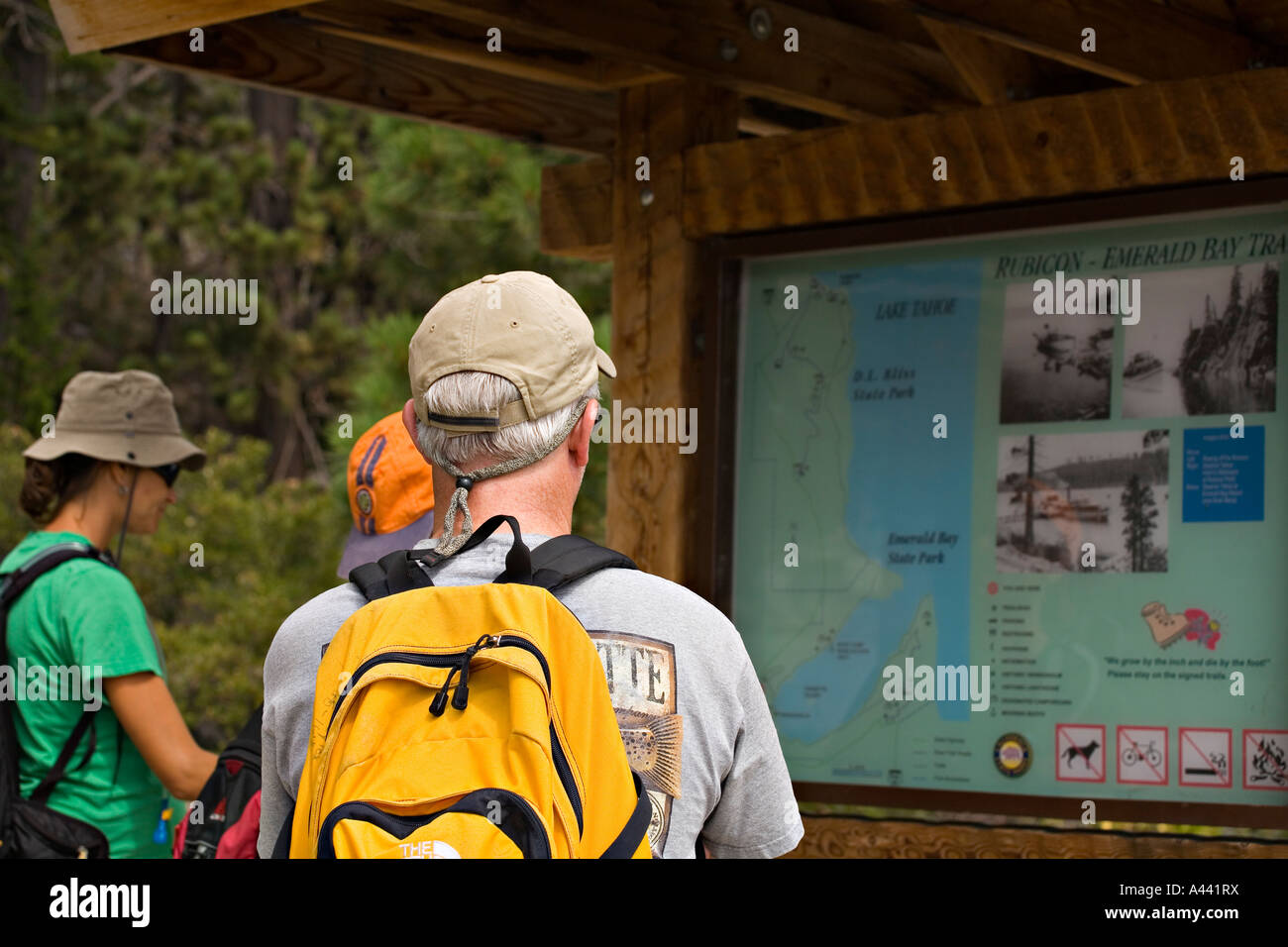 CALIFORNIA Lake Tahoe Day hikers with backpacks look at Rubicon Emerald ...