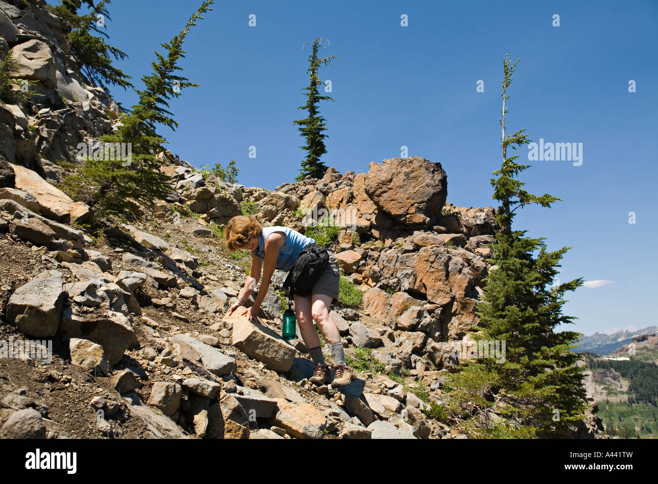 CALIFORNIA Lake Tahoe Woman scramble over rocks on steep hillside Ward ...