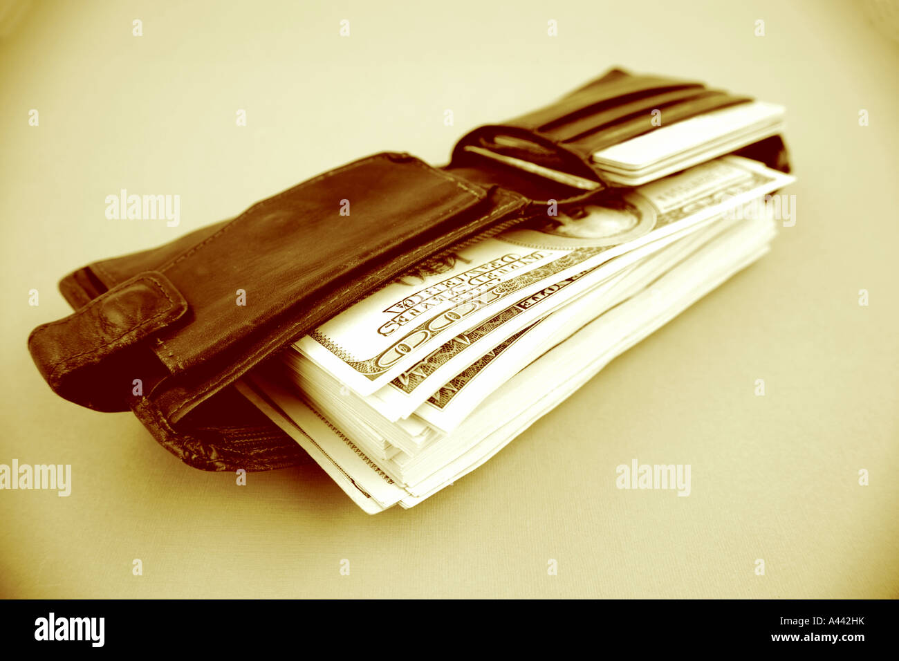 Wallet full of money Stock Photo - Alamy