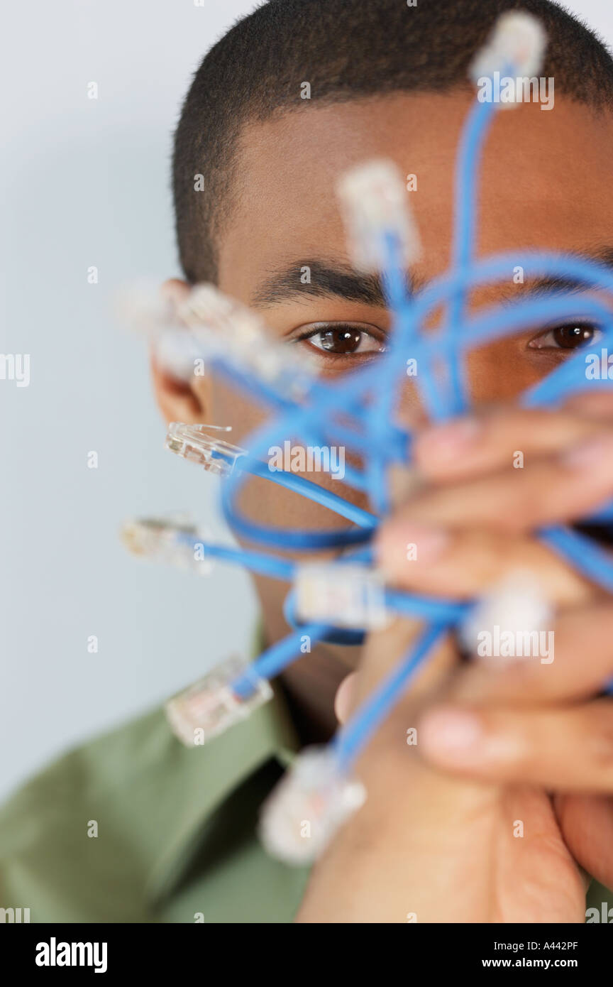 Young man holding Ethernet cables Stock Photo - Alamy