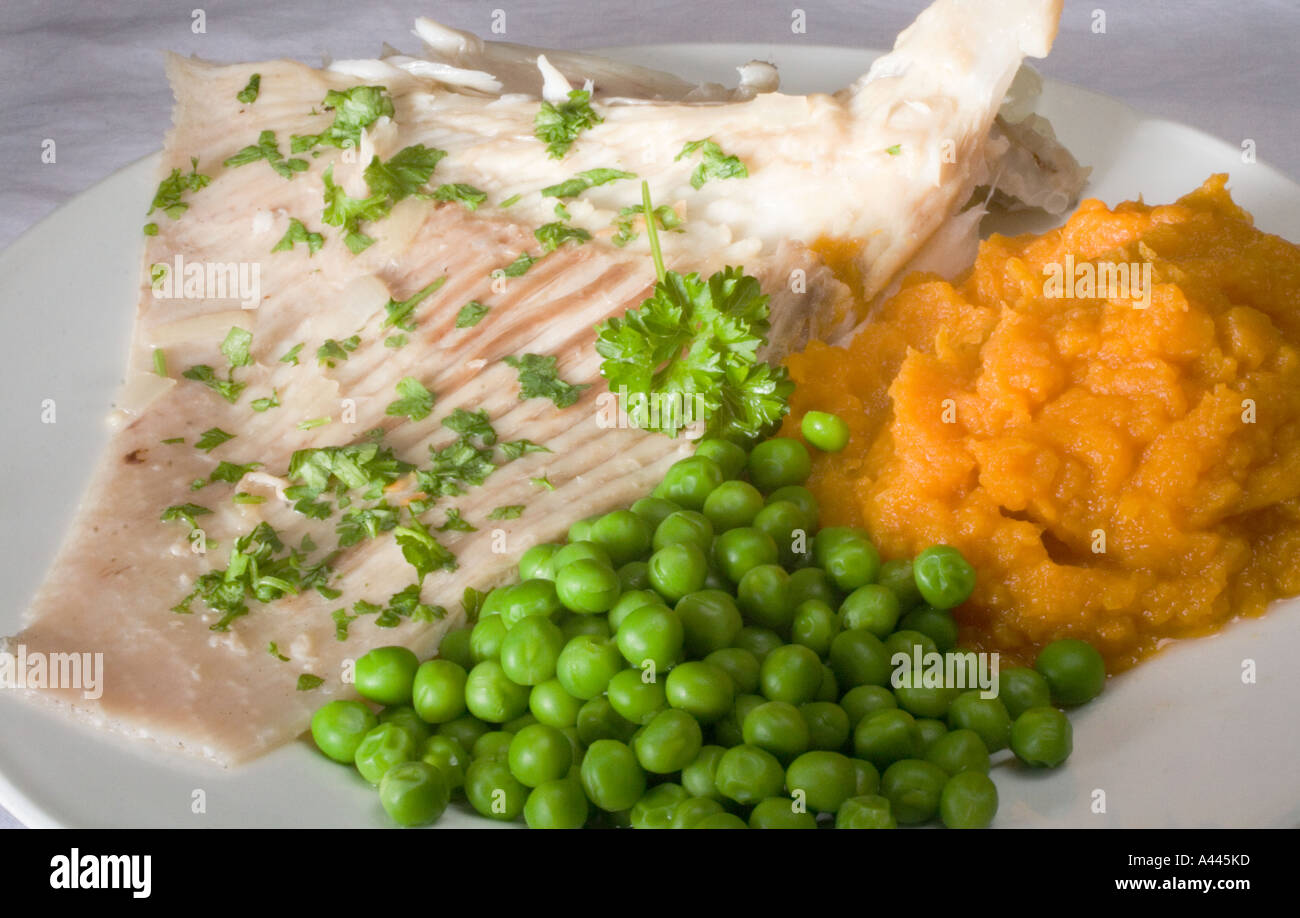 Cooked skate wing mashed sweet potatoes and garden peas Stock Photo - Alamy