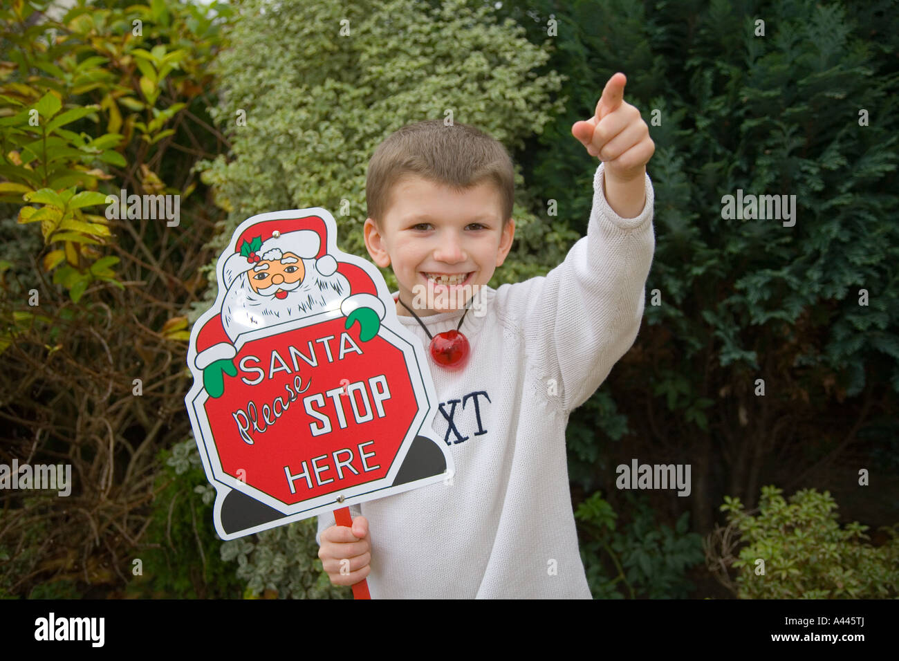 young boy holding santa xmas sign red smile Stock Photo - Alamy