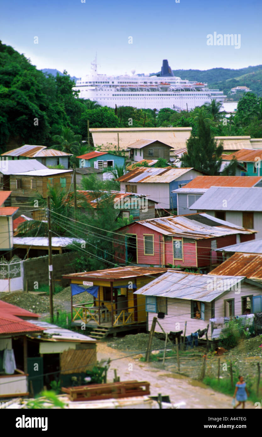 cruise ship moored at Roatan Honduras with colorful town huts and ...