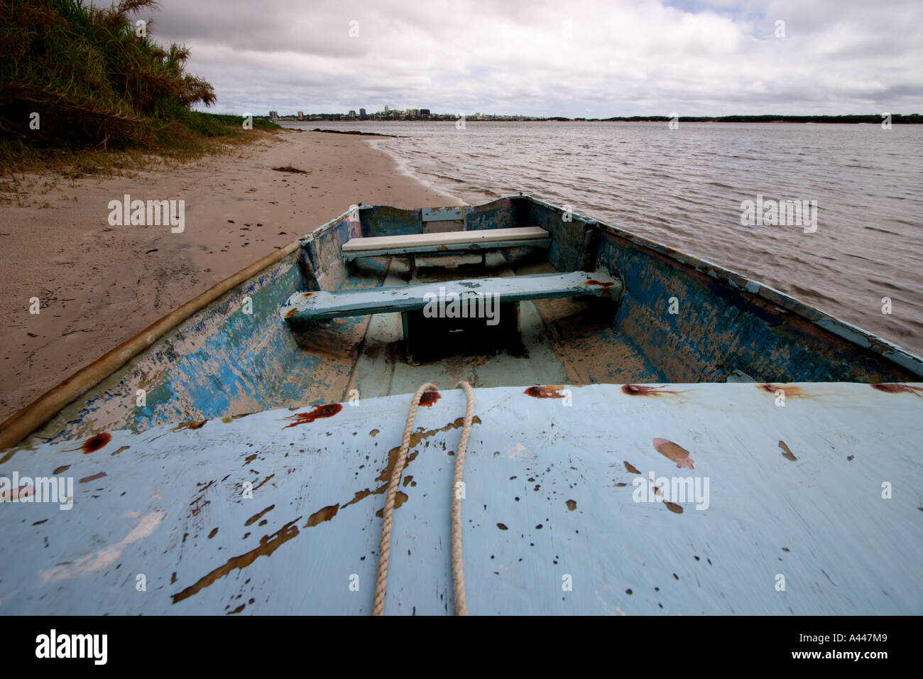 BLUE ROWBOAT WASHED UP ON BEACH Stock Photo - Alamy