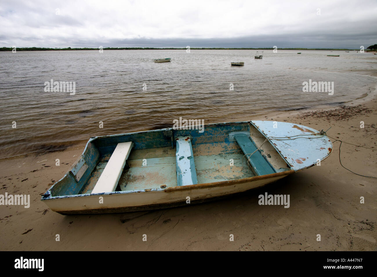 BLUE ROWBOAT WASHED UP ON BEACH Stock Photo - Alamy