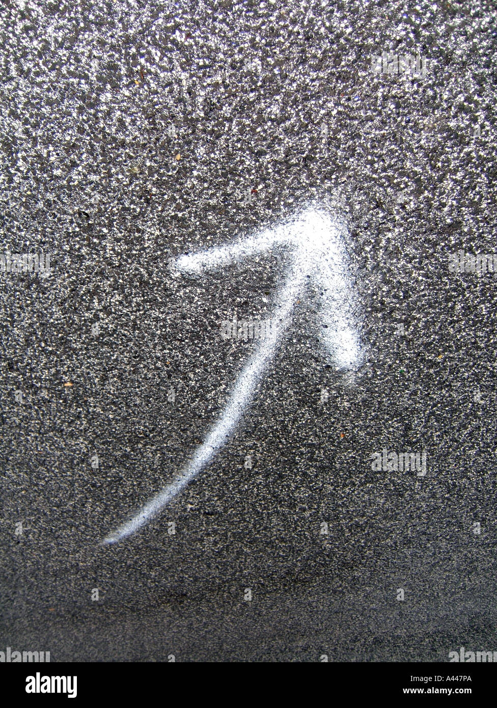 one white arrow painted on wet road Stock Photo - Alamy