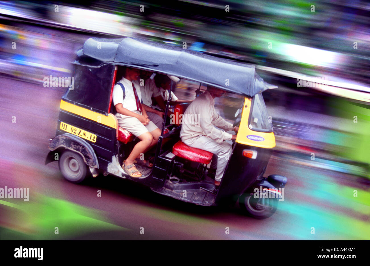 An auto rickshaw speeds its way through Mumbai’s crowded suburbs Stock ...