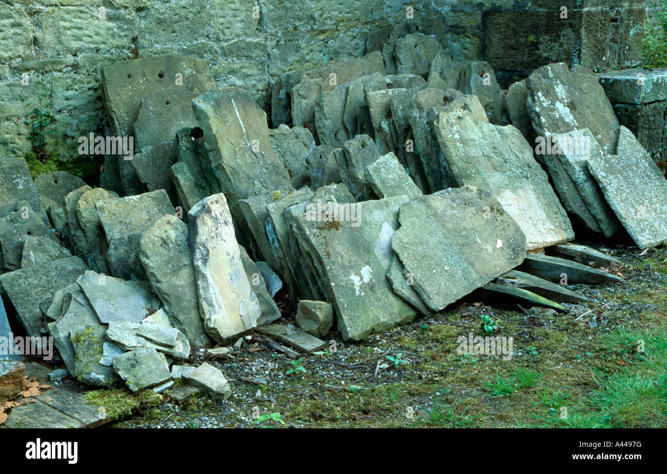 Reclaimed slate and stone slabs leaning against wall Stock Photo - Alamy