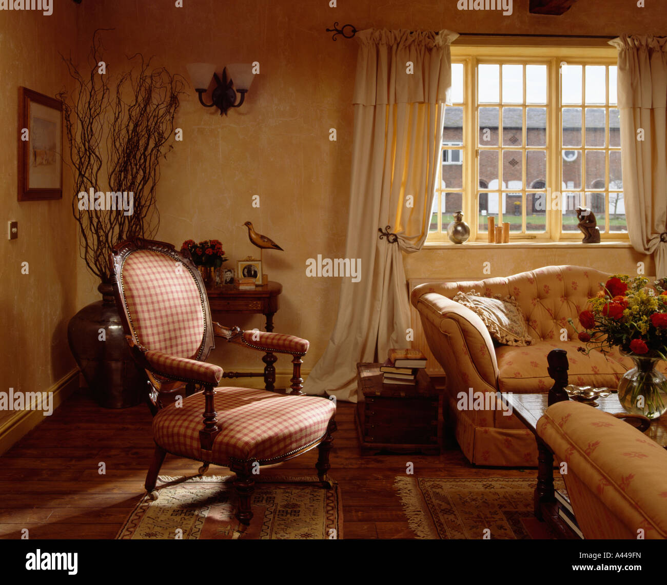 Red and white checked Victorian armchair in front of window in ...