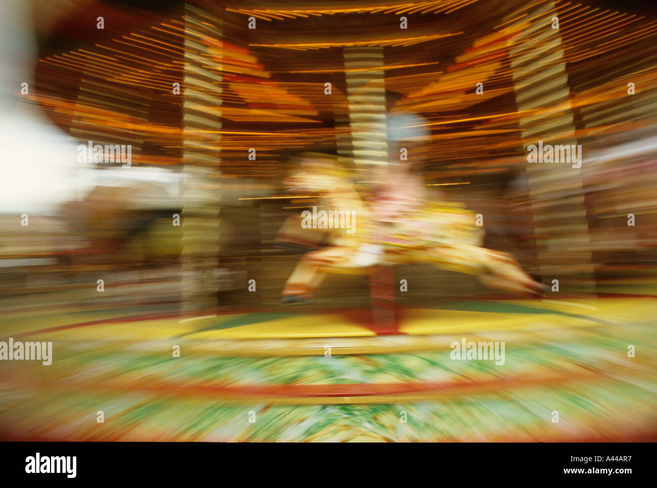 Fairground hobby horse roundabout spinning fast Stock Photo - Alamy