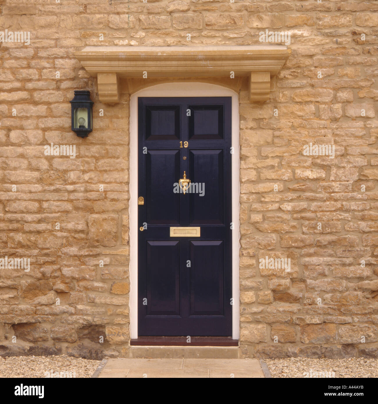 Black door in traditional cotswold stone wall Stock Photo - Alamy