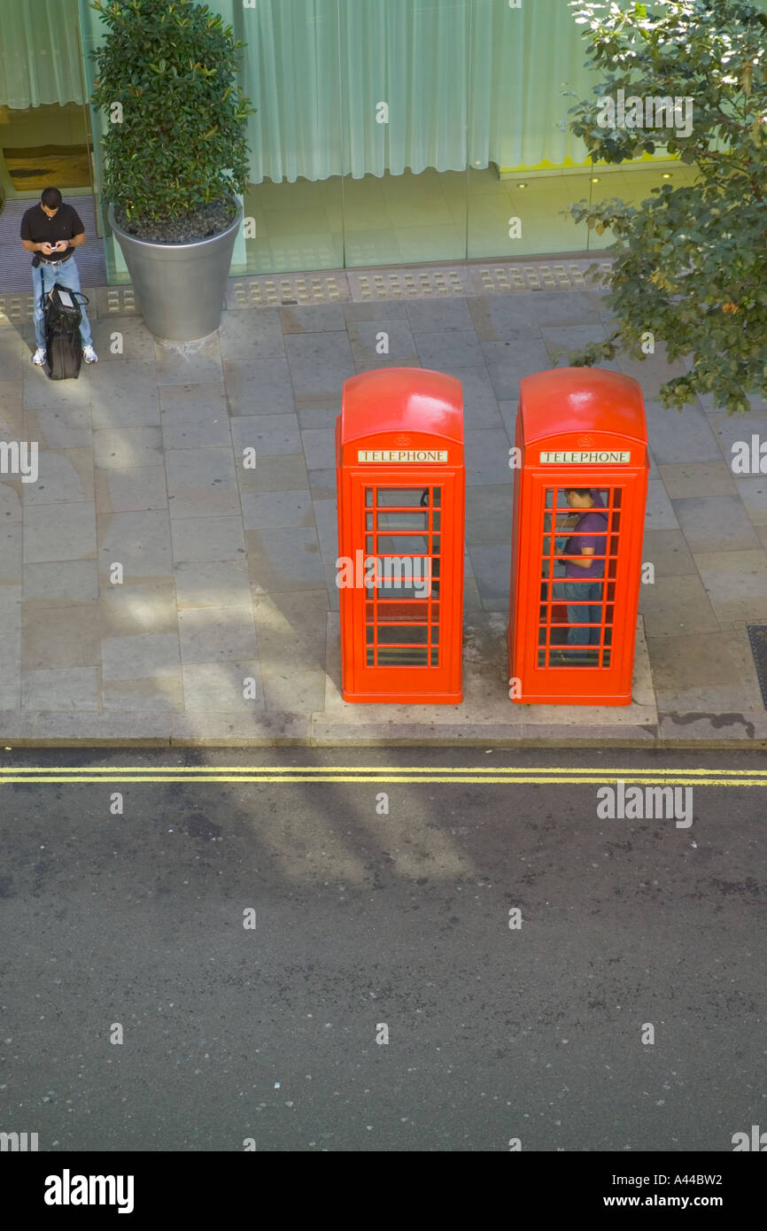 Red phone boxes at roadside in London Stock Photo - Alamy