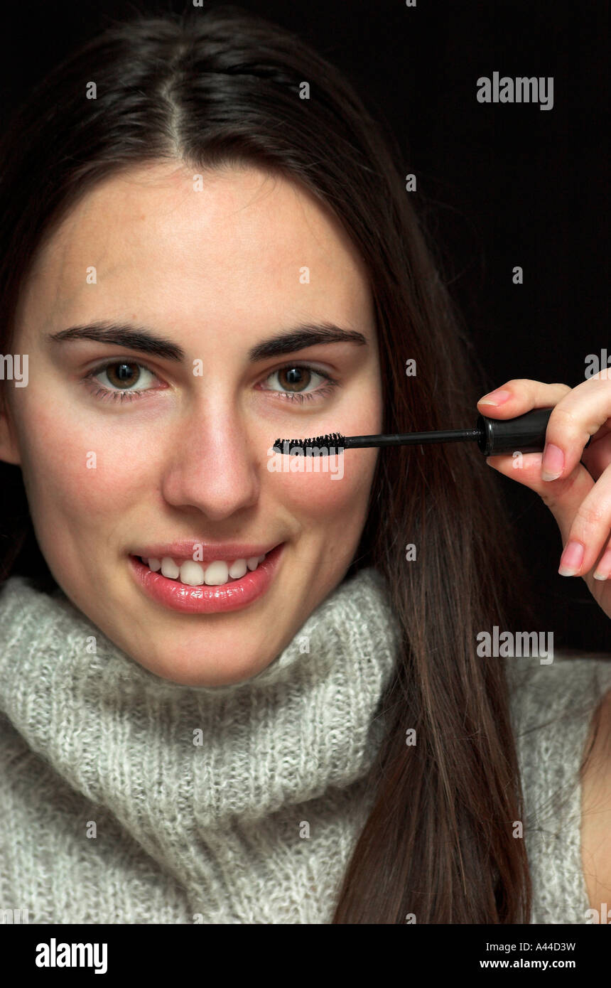 Young woman holding mascara Stock Photo - Alamy