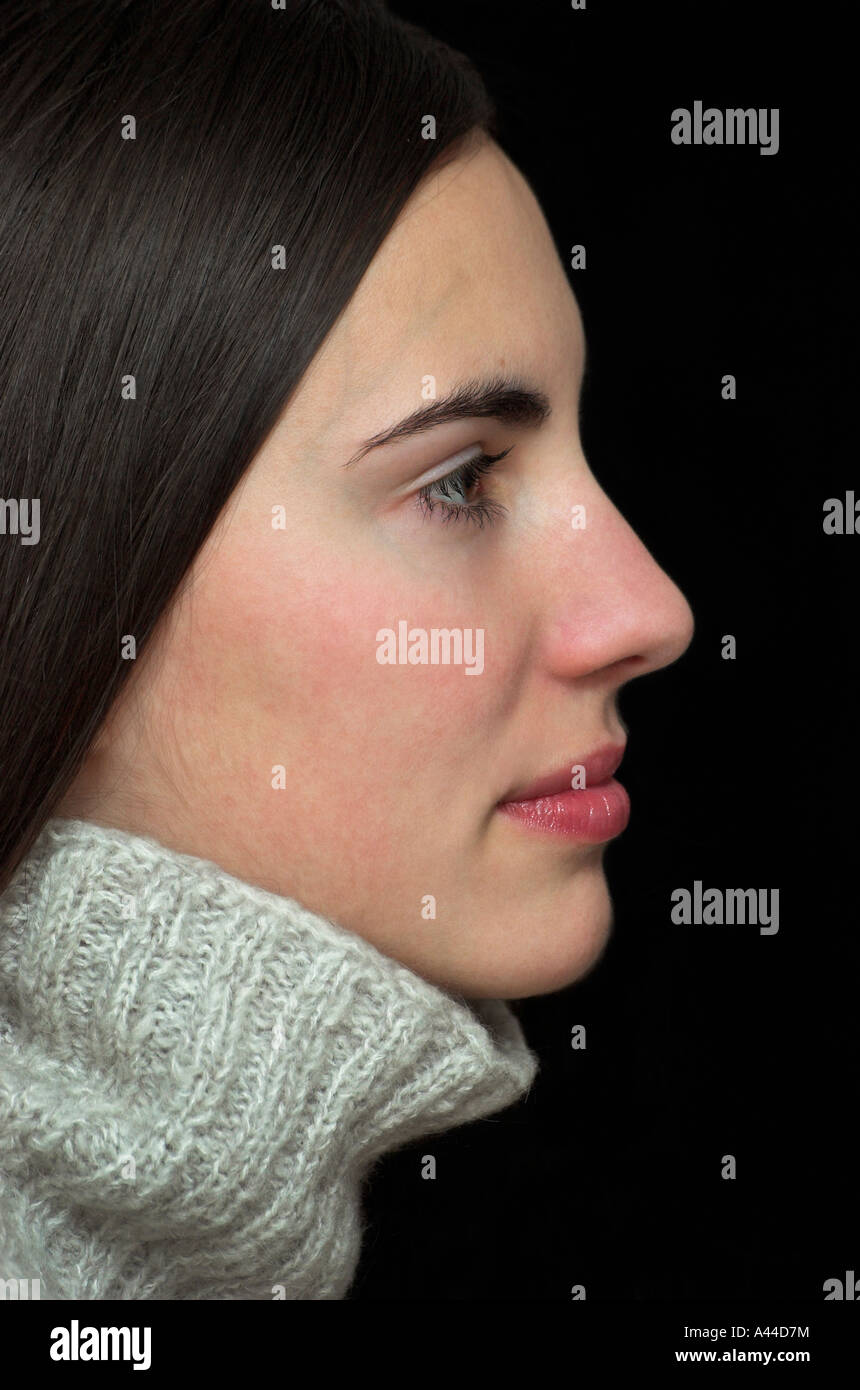 Portrait of a serious young woman side view Stock Photo - Alamy