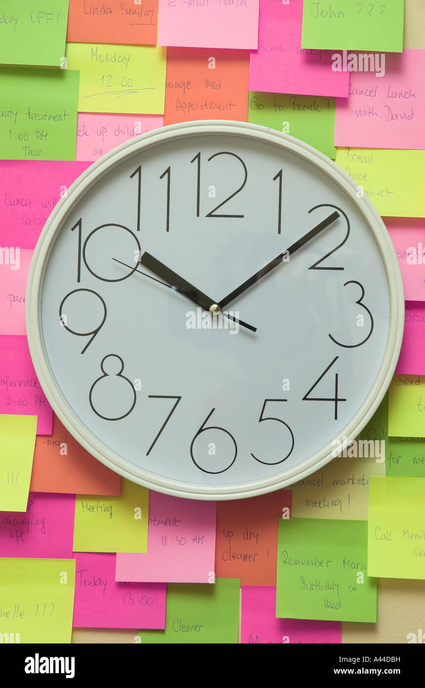 Clock surrounded by sticky notes Stock Photo - Alamy