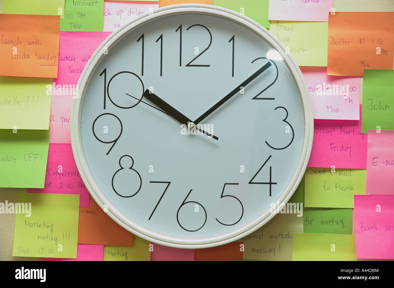 Clock surrounded by sticky notes Stock Photo - Alamy