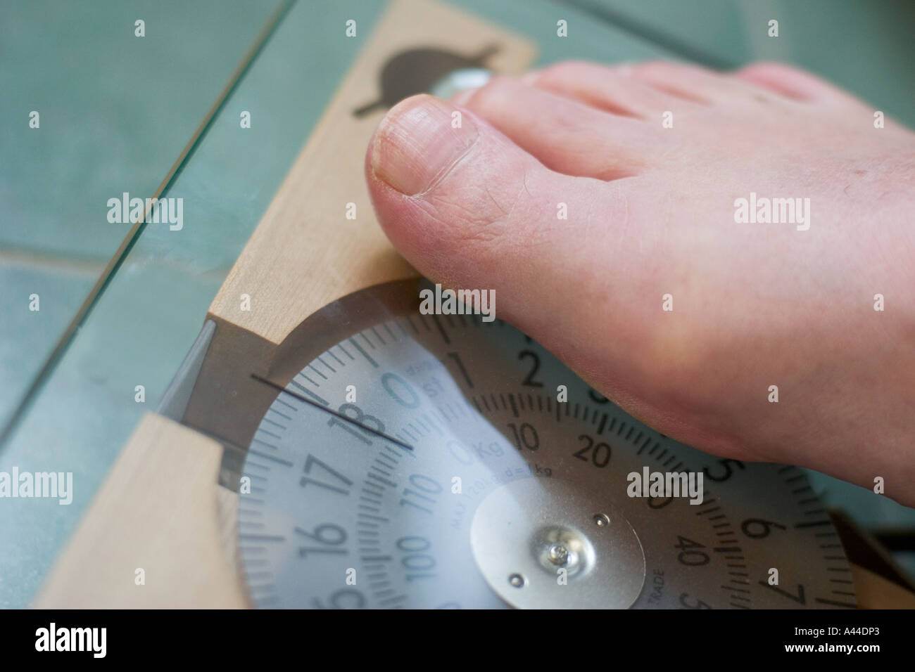 250 pound 120kg man weighs himself on bathroom scales Stock Photo - Alamy