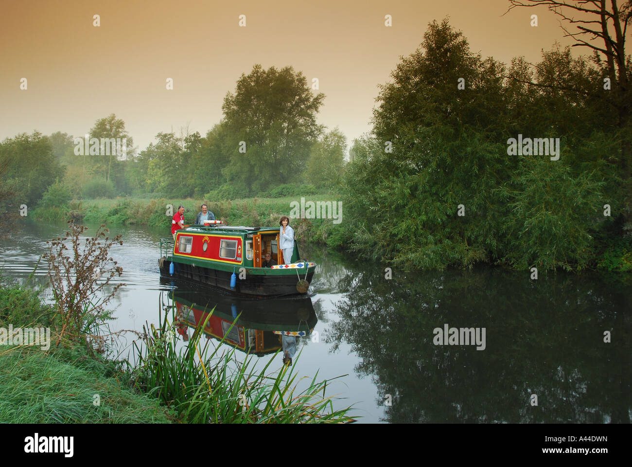 A canal boat cruises along the river Chelmer at Little Baddow near ...