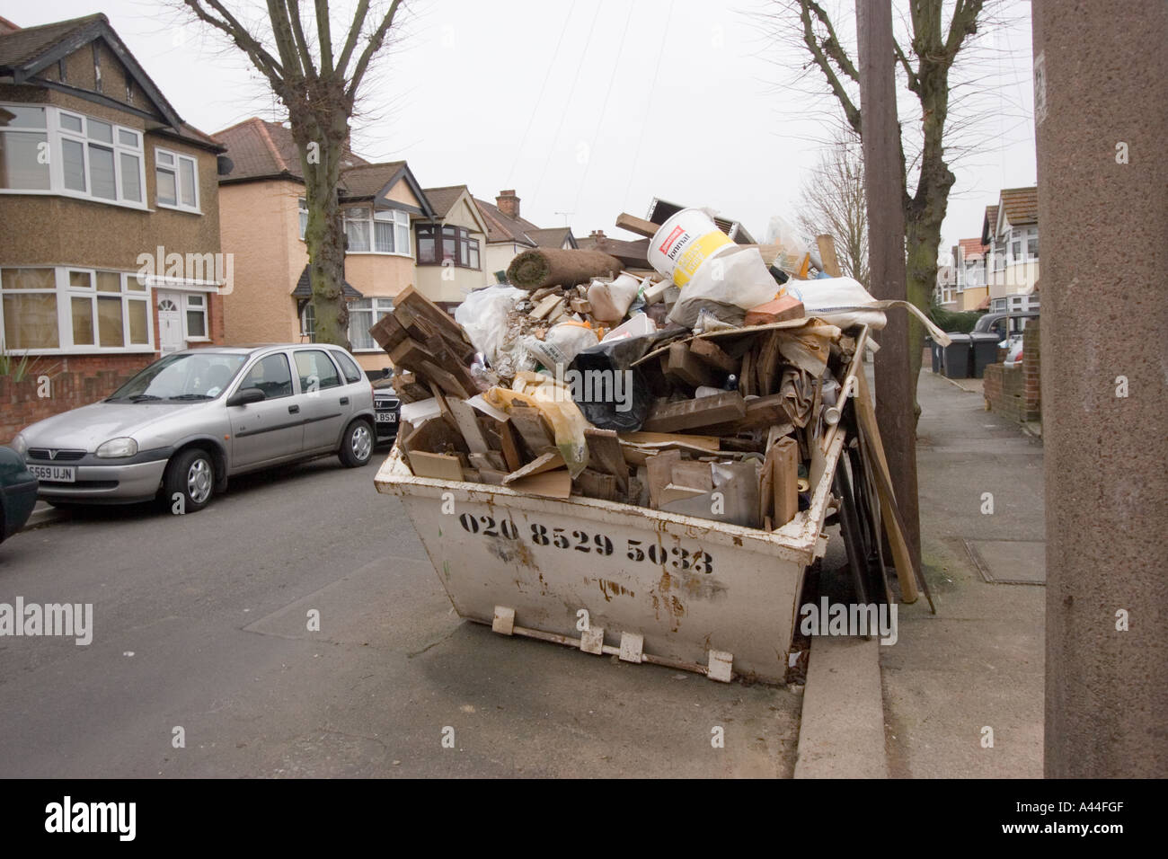 Overloaded skip in road hi-res stock photography and images - Alamy
