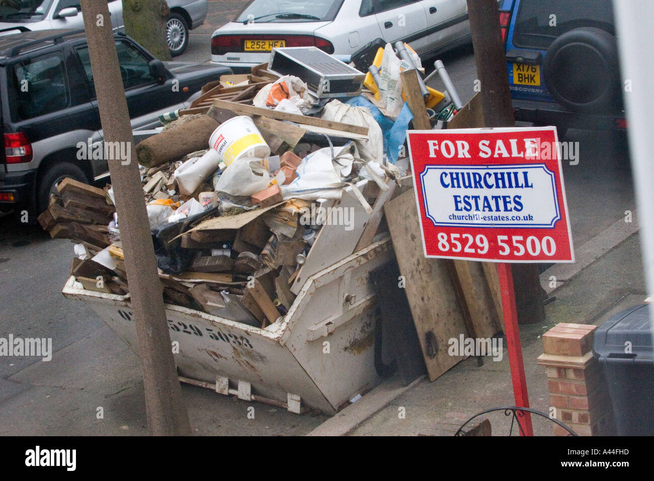 Unlicensed and Overloaded Skip in road, full of DIY rubbish outside ...