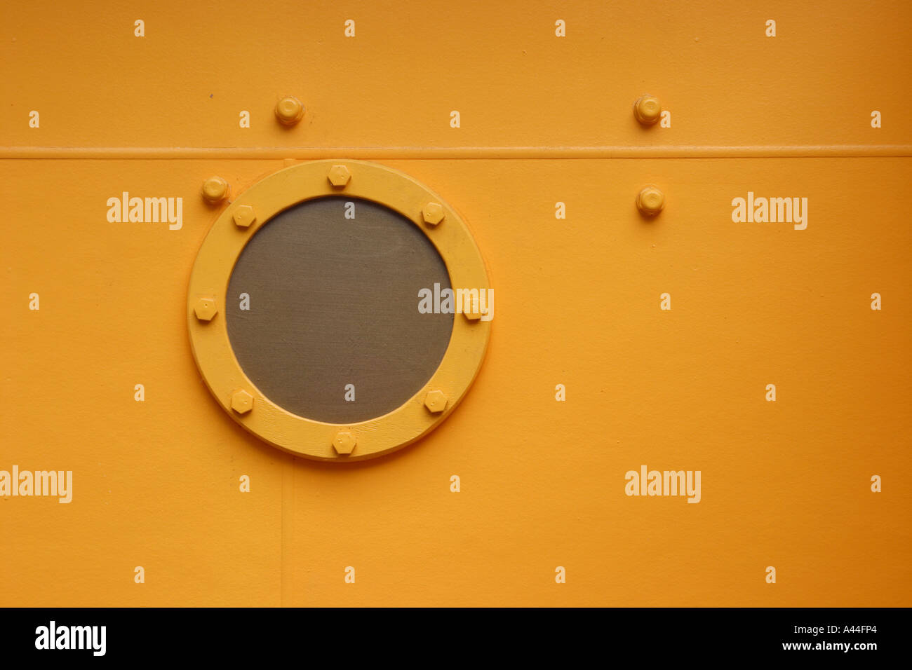 close up of a porthole on the side of a red and yellow ship Stock Photo ...